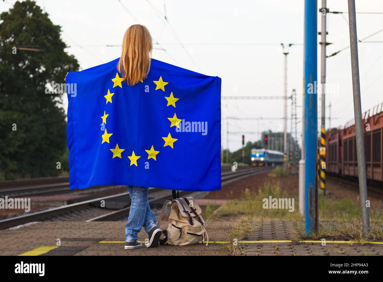 Traveling through the European Union by train. Backpacker with EU flag ...