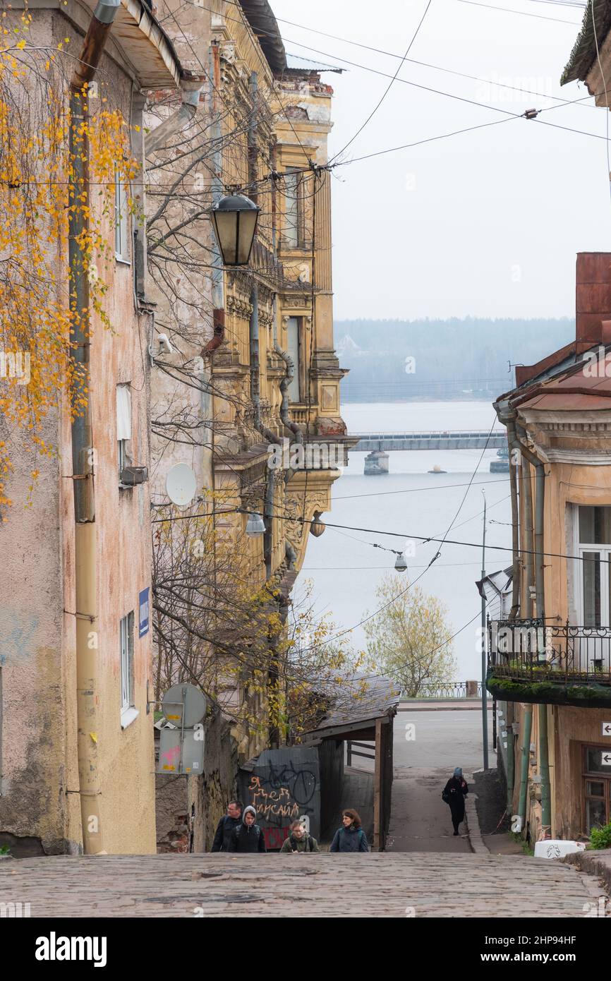 Tourists walk along the old hills of Vyborg. ?loudy autumn day. View on ...