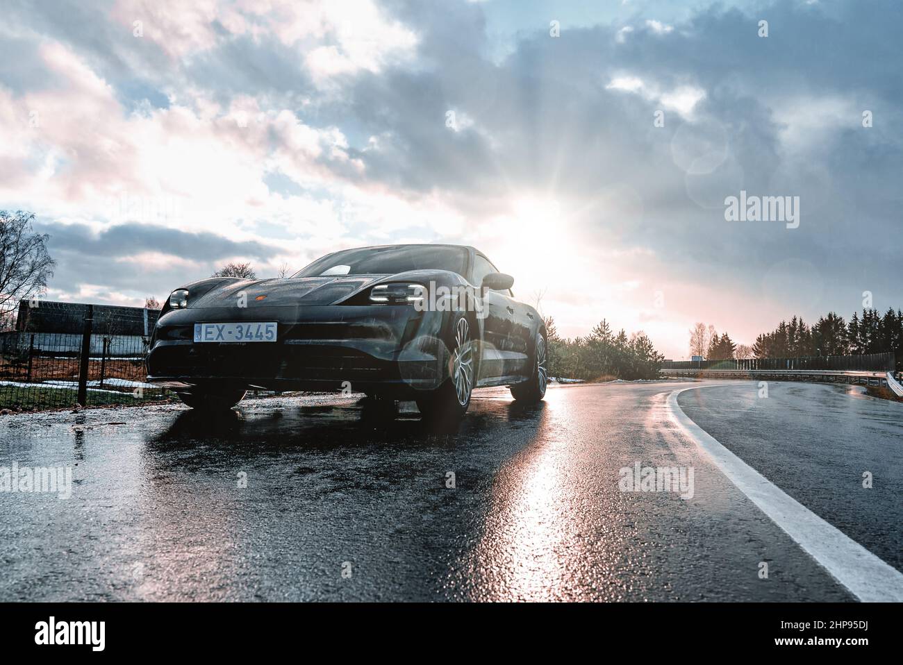 Porsche Taycan Gran Turismo Electric model driving down the road Stock ...