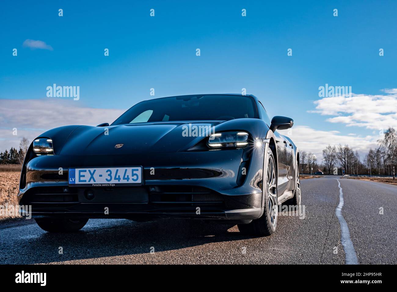 Porsche Taycan Gran Turismo Electric model driving down the road Stock ...