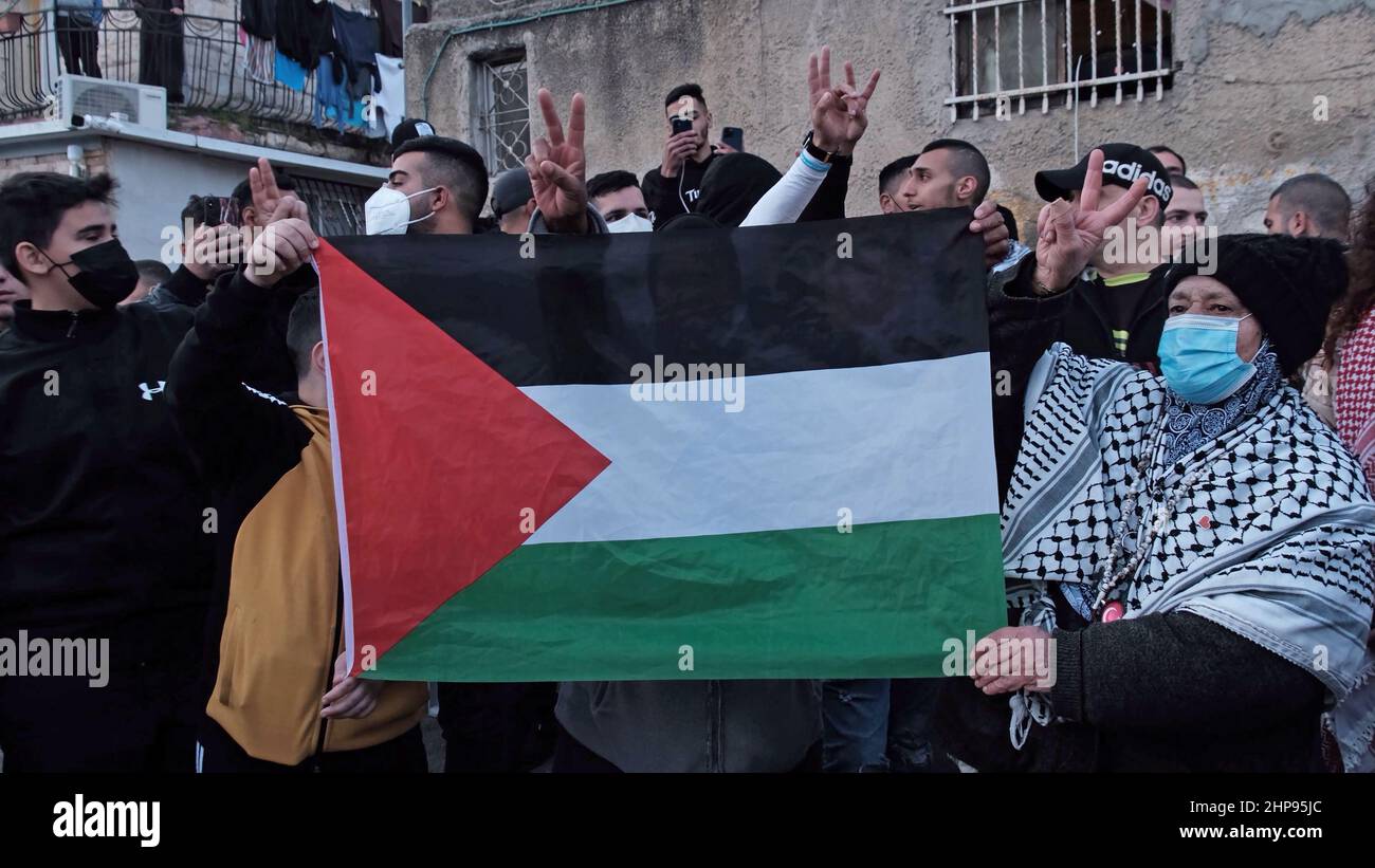 Palestinians hold up the victory sign and the Palestinian flag during a ...