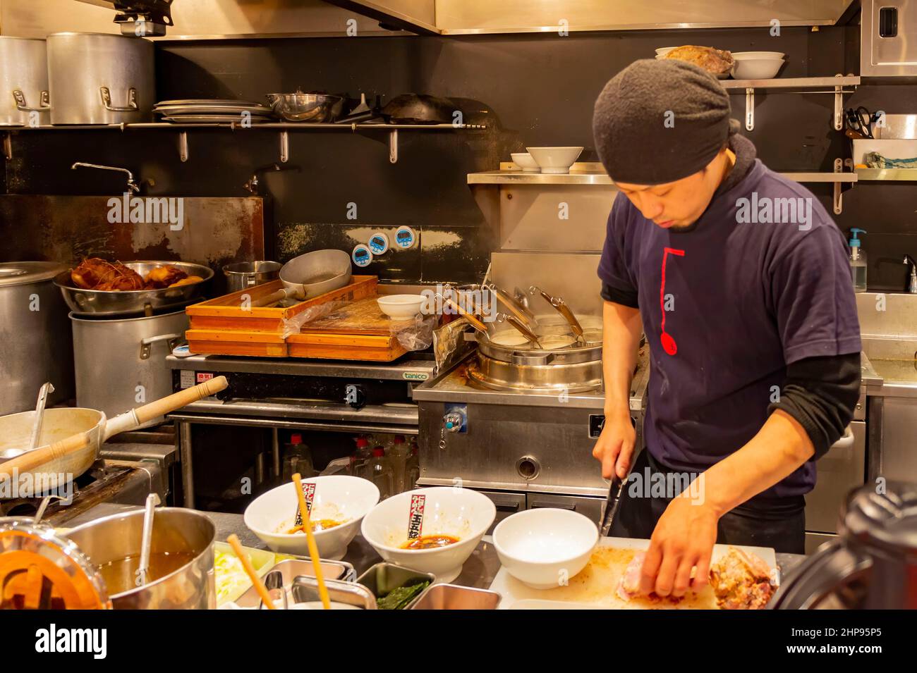 Osaka, APR 29 2011 - Close up shot of a chief cooking ramen in ...