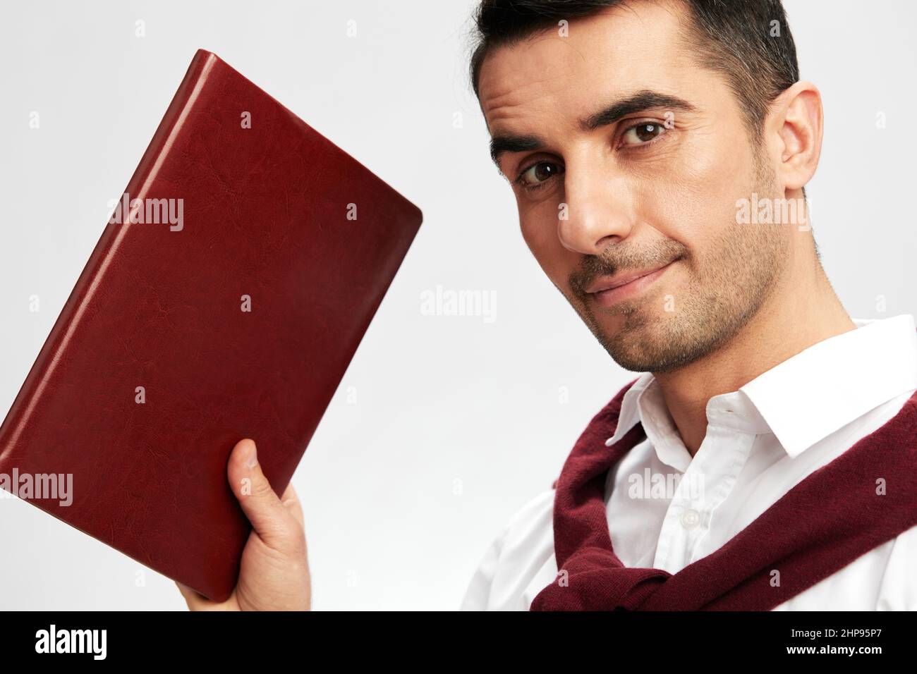 successful man in a white shirt sweater on the shoulders notebook ...