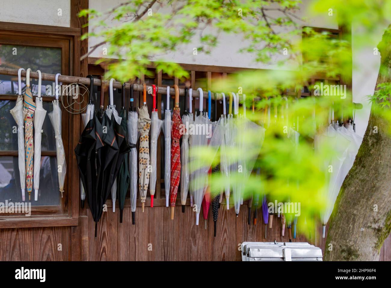Kyoto, MAY 1 2011 - Exterior view of a wooden house with many umbrella ...