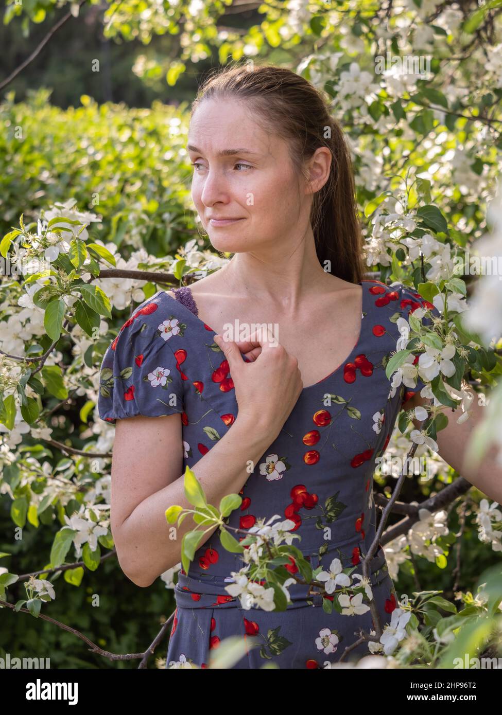 Beautiful Young woman without makeup in a spring park among flowering ...