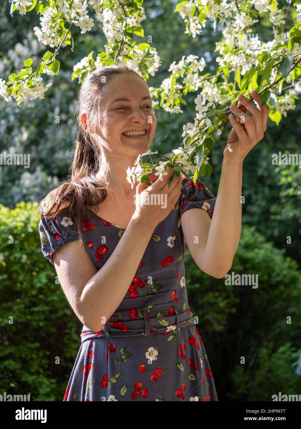 Beautiful Young woman without makeup in a spring park among flowering ...