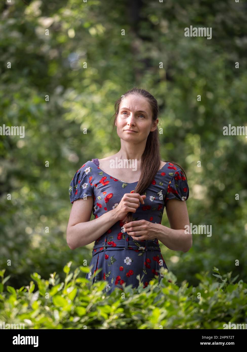 Beautiful Young woman without makeup in a spring park among flowering ...