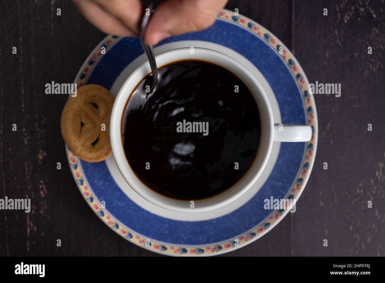 Top view of a hand stirring the coffee Stock Photo - Alamy