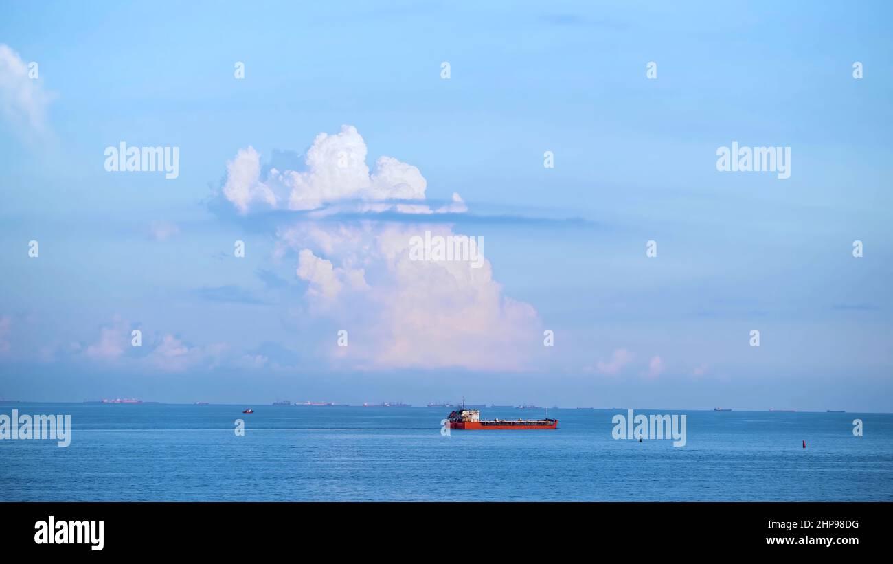 Breathtaking seascpe with a sailing red barge on blue cloudy sky on the ...
