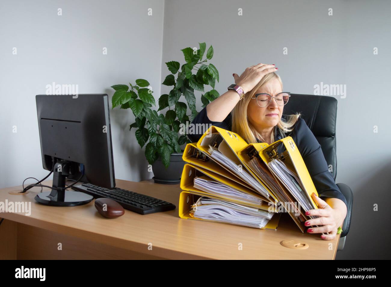Overworked woman in the office with numerous paper files Stock Photo ...