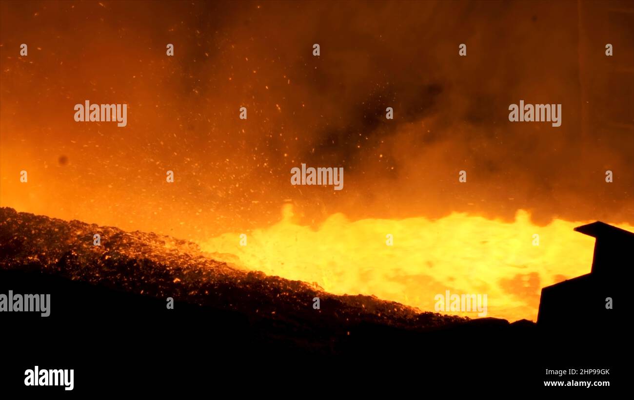 Close up for liquid metal flowing from blast furnace at the ...