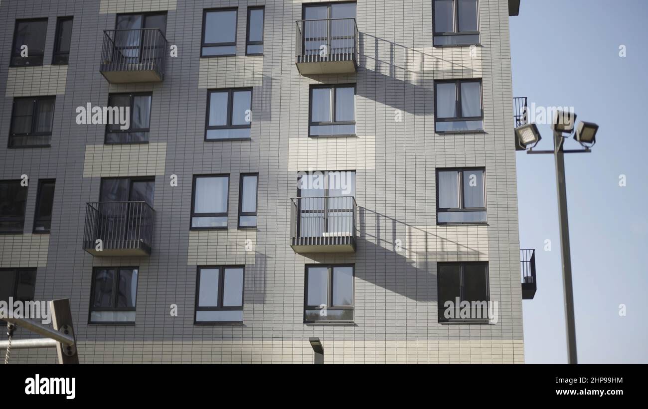 Bottom view of residential new building made of white bricks. Fragment ...