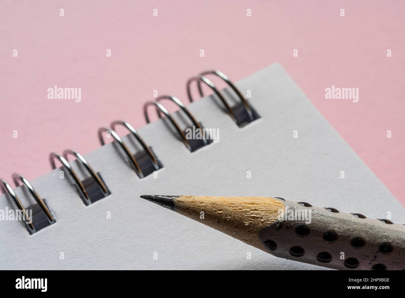 the tip of a pencil on a spiral notepad Stock Photo - Alamy