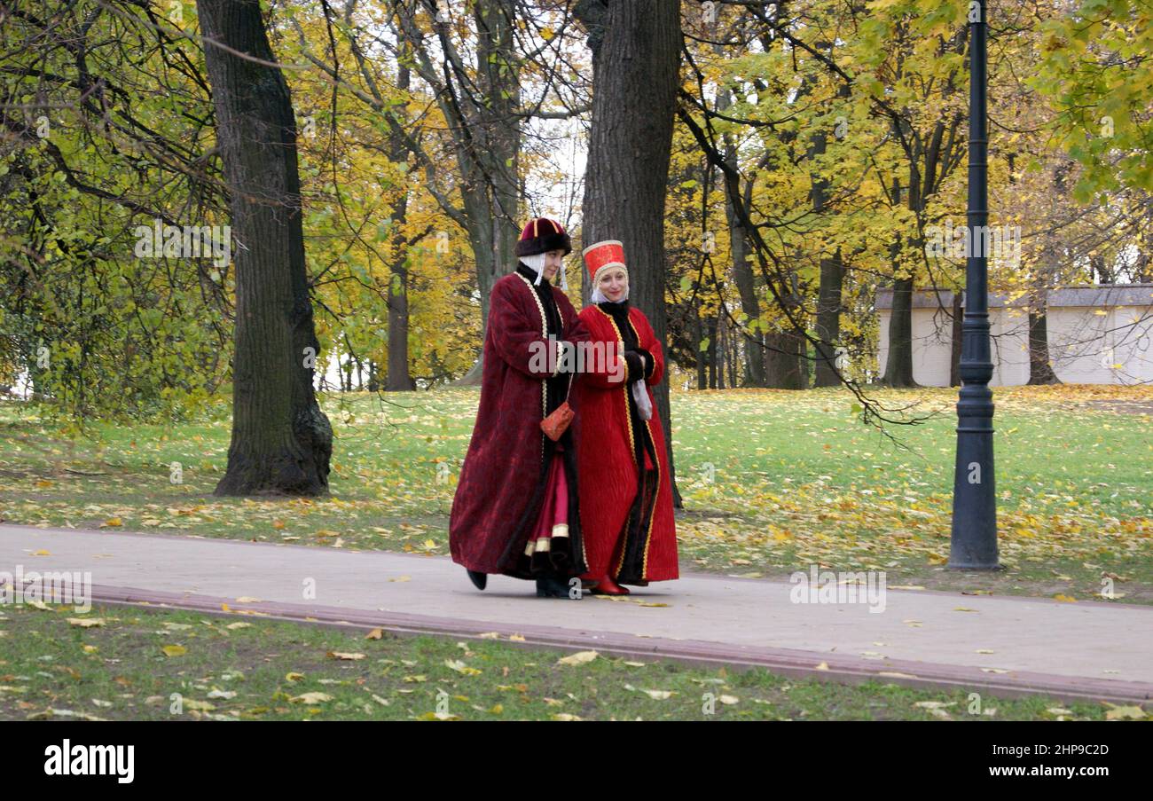 Female guides, wearing ornate traditional Russian garments, walking in ...
