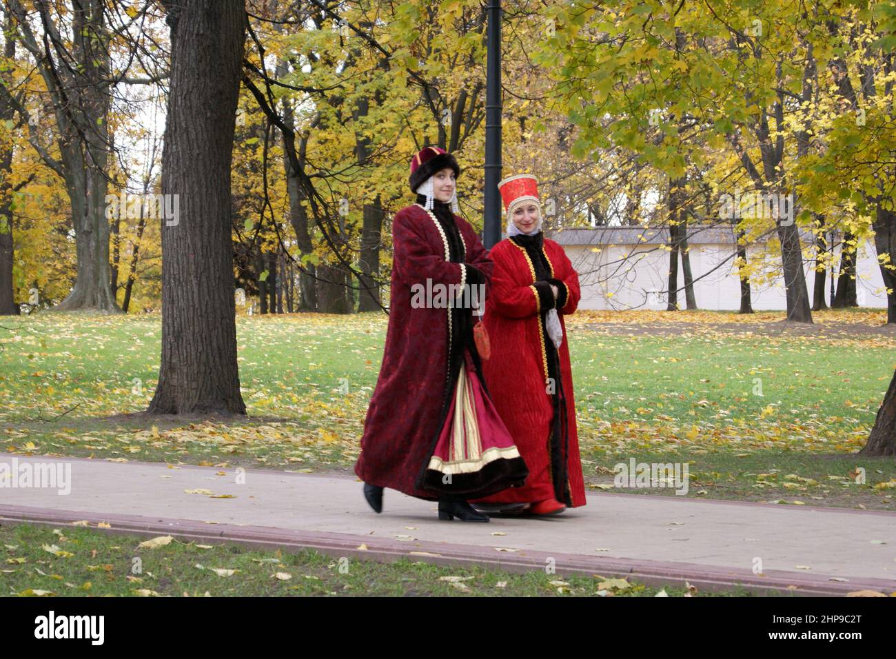 Female guides, wearing ornate traditional Russian garments, walking in ...