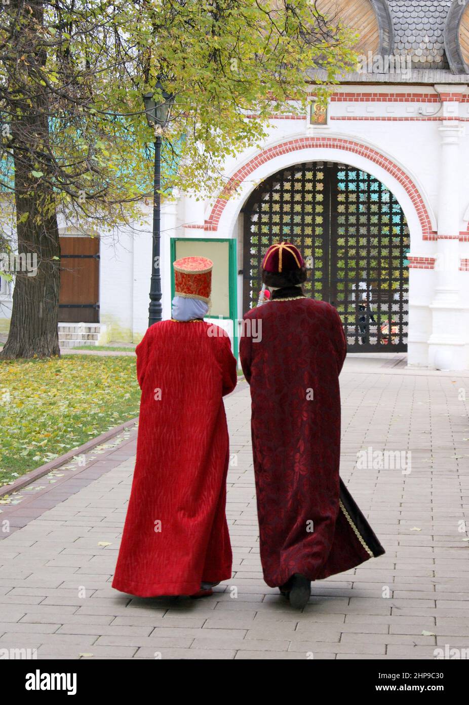 Female guides, wearing ornate traditional Russian garments, walking in ...