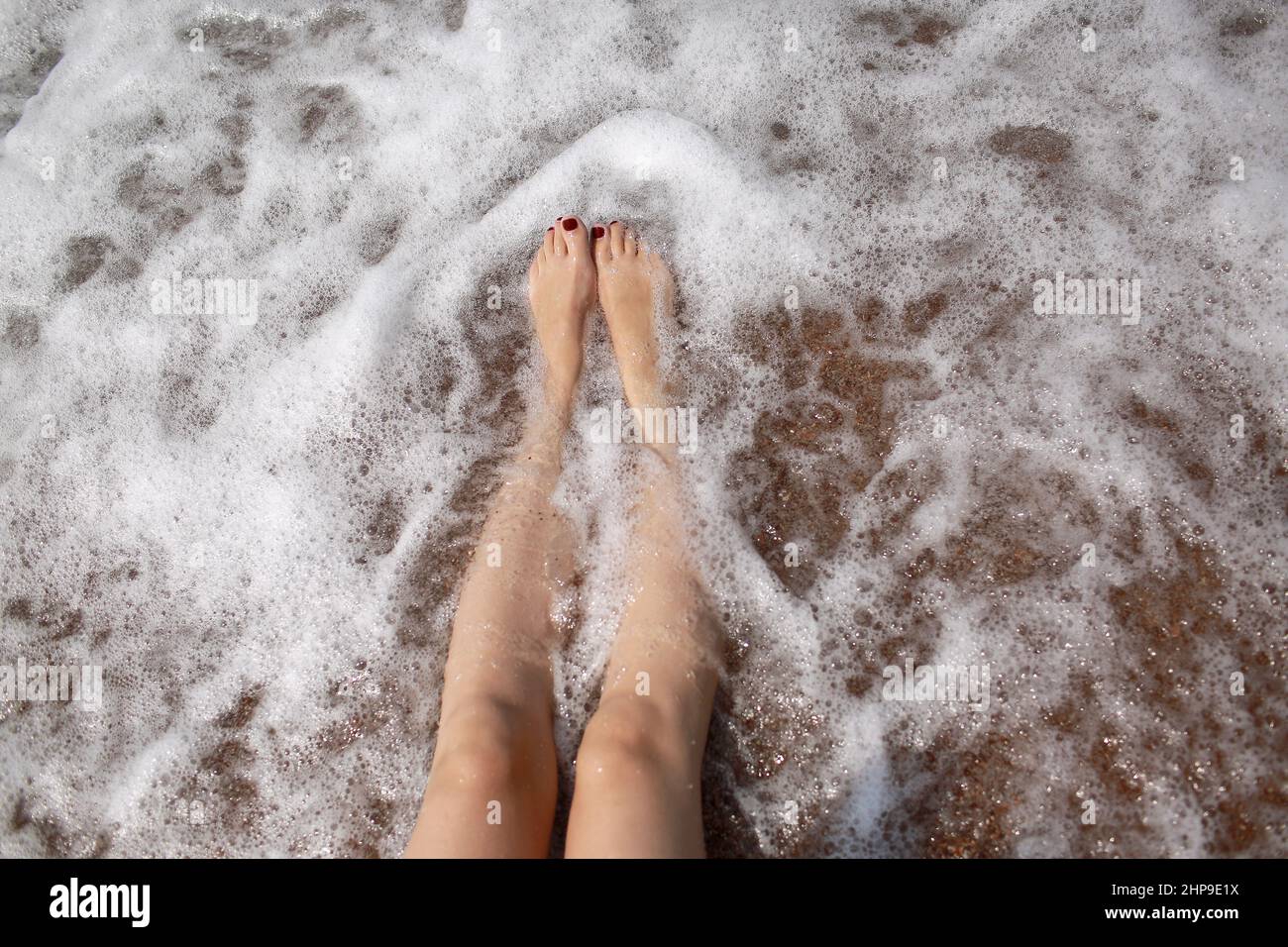 Travel Concept Womans Legs On Beautiful Tropical Beach With Pebble