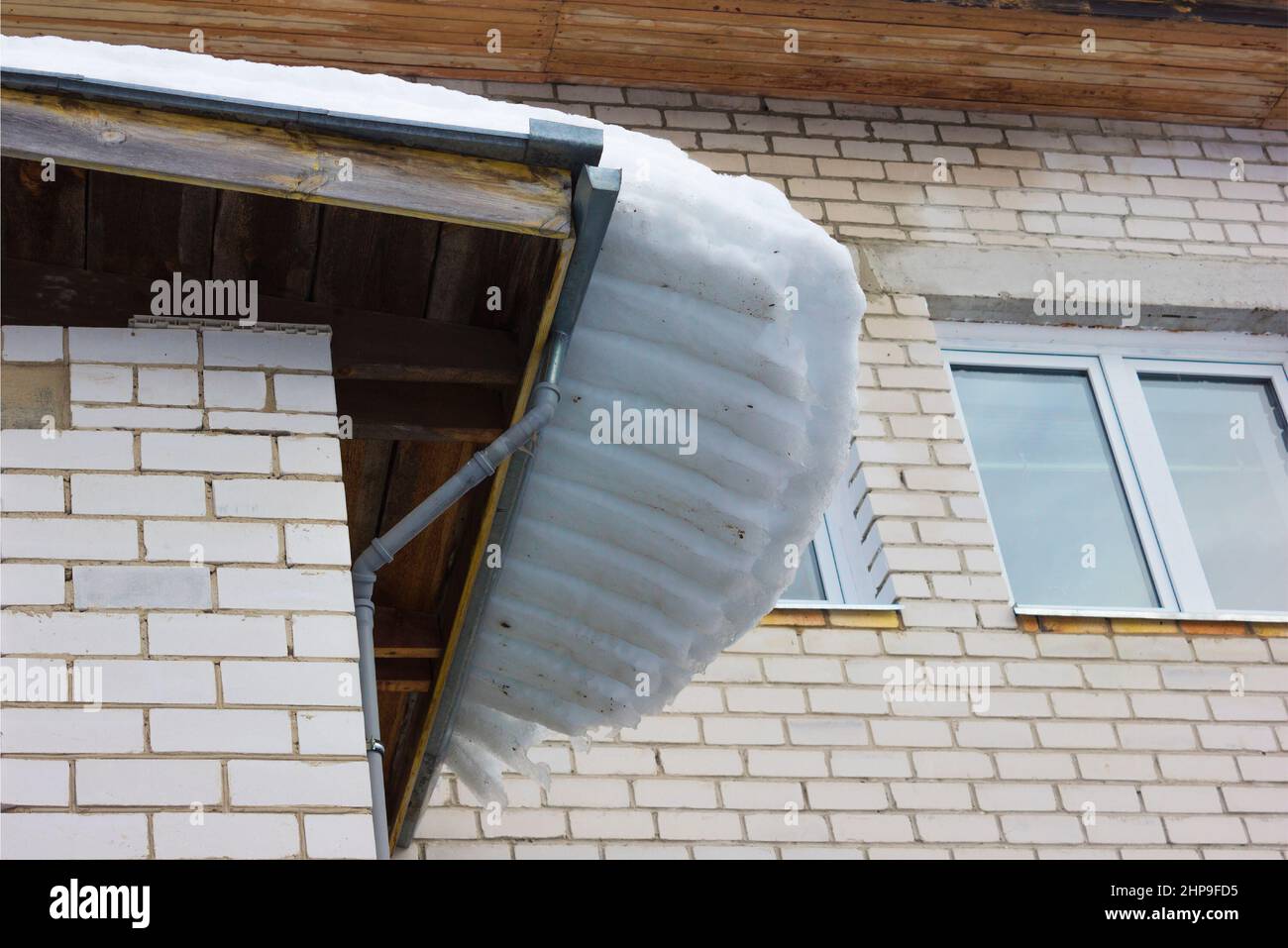 Threat of snow falling from roof. Photo was taken on the eve of spring ...