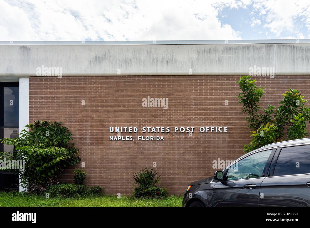 Naples city town in southwest Florida with Post Office sign on building ...