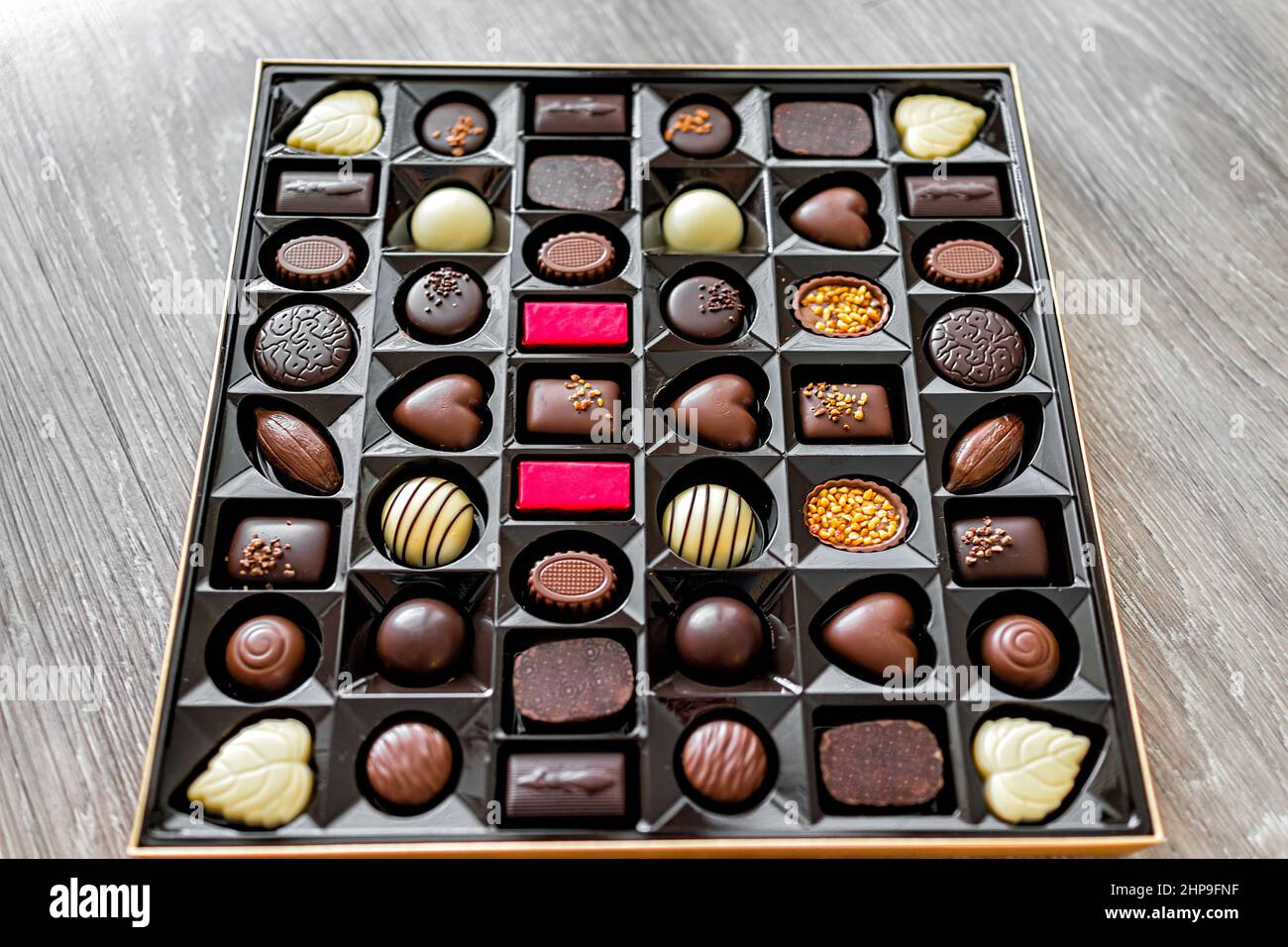 Open box of chocolates truffles with luxury gourmet milk and dark ...