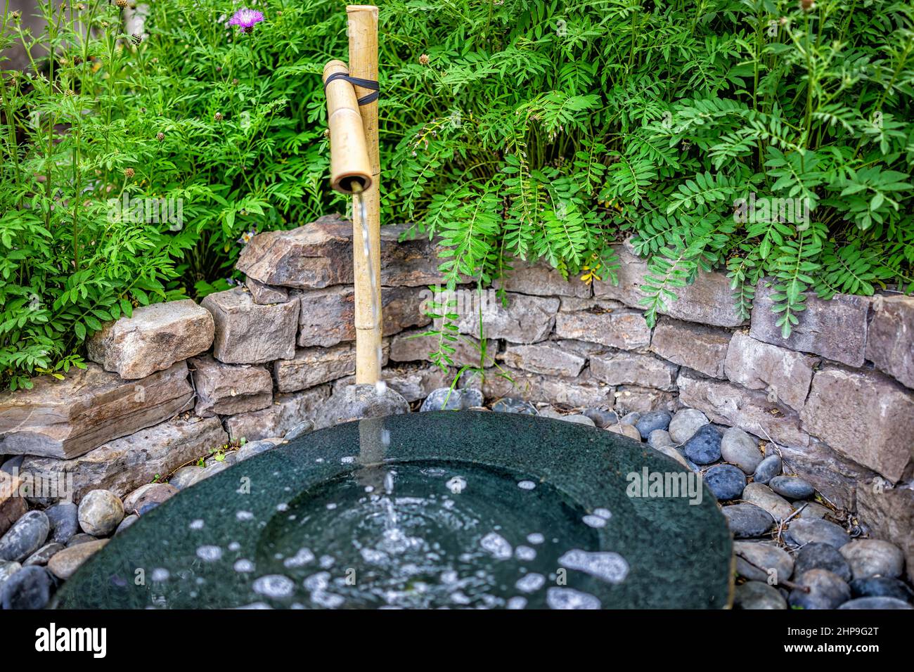 Purification fountain in Japan with water running from spout faucet in ...