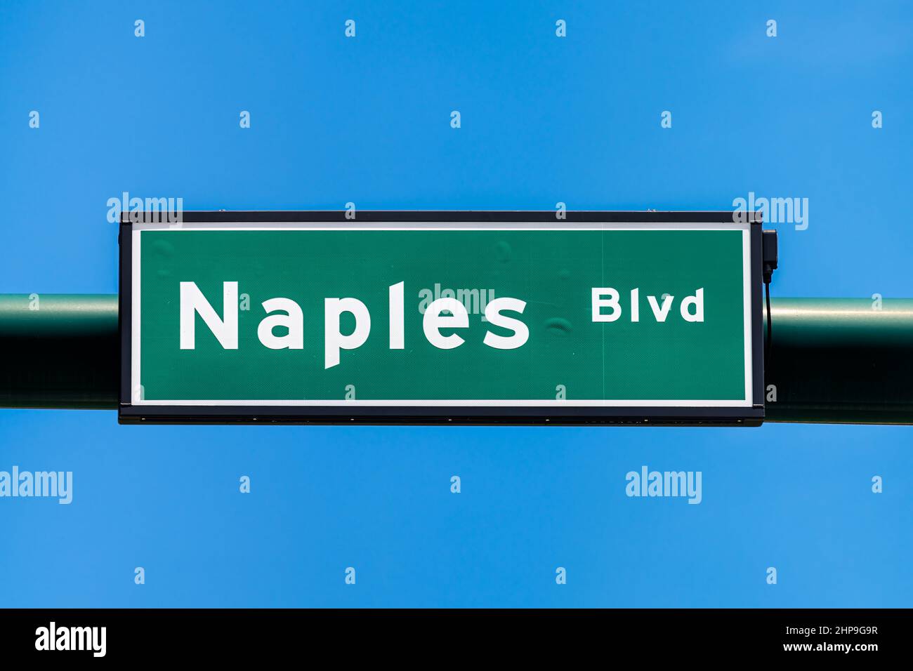 Naples Boulevard road sign closeup isolated against blue background in ...
