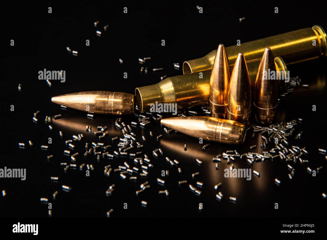 Close-up of disassembled rifle cartridges. Bullet isolated on black ...