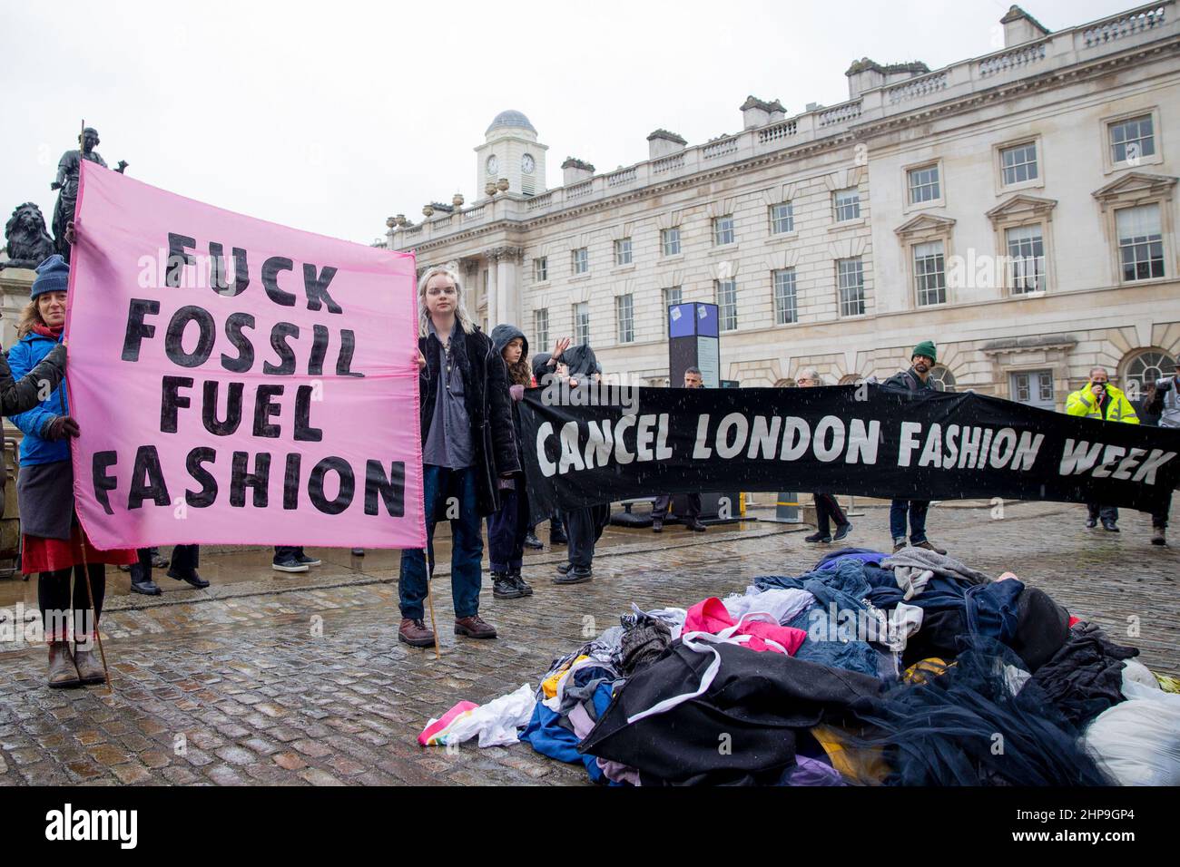 London, UK. 19th Feb, 2022. Protesters hold banners and put a pile of ...