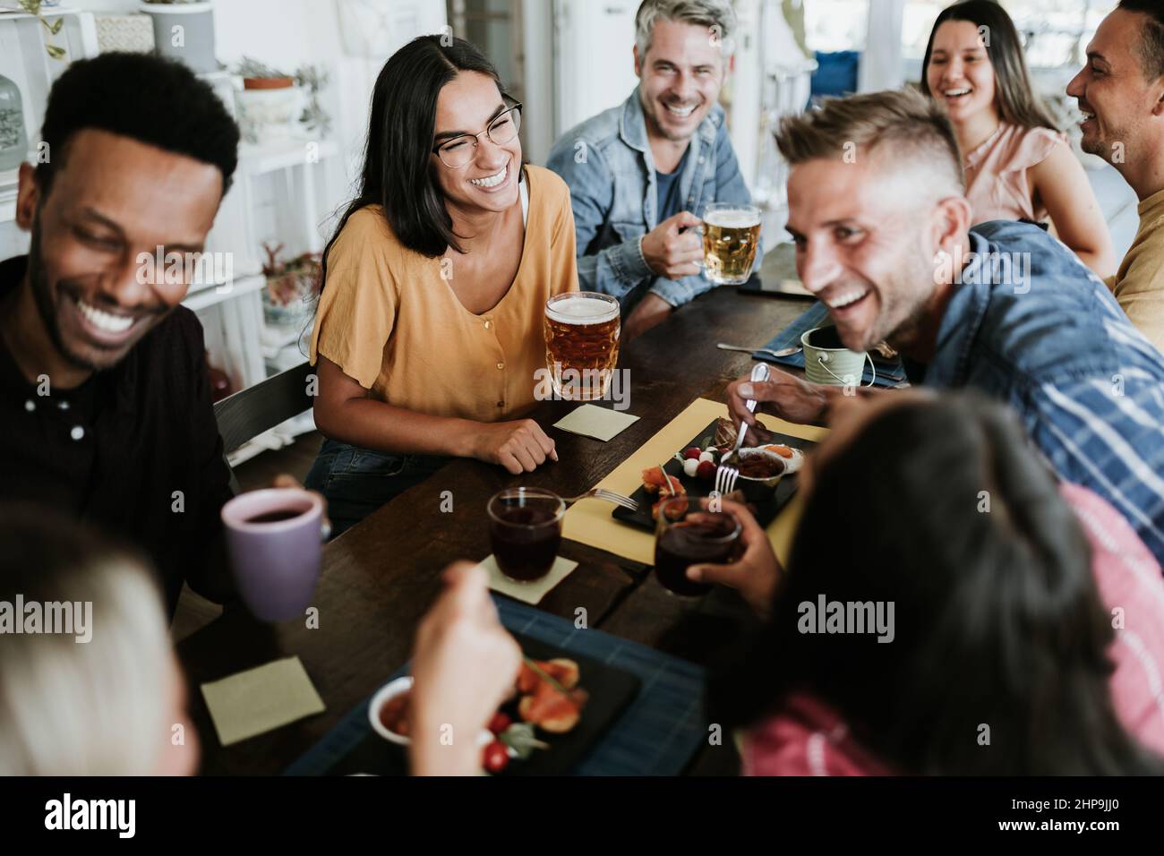 Happy group of young friends people having breakfast at bar bakery shop ...