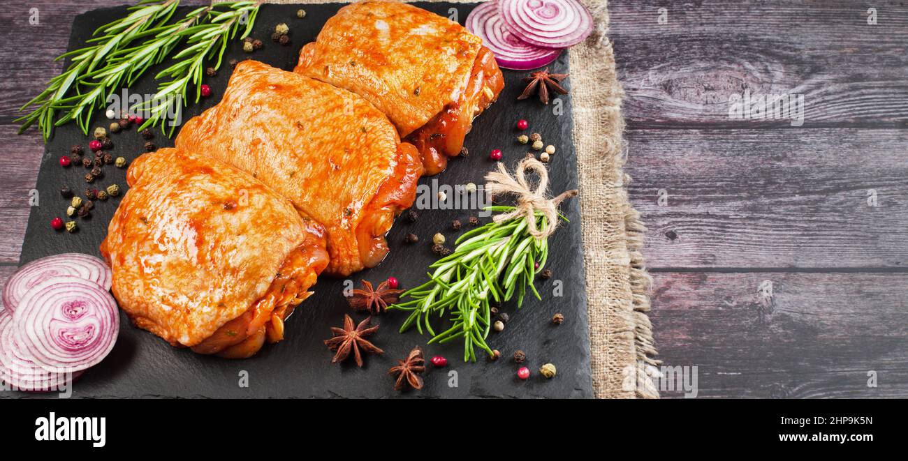 Background for a banner of chicken thighs with spices.Raw Marinated ...