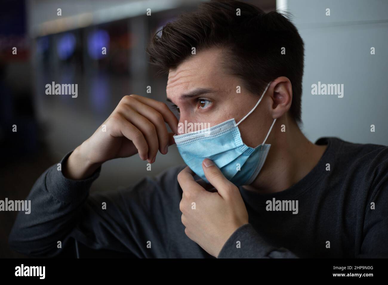 Touching a mask hi-res stock photography and images - Alamy