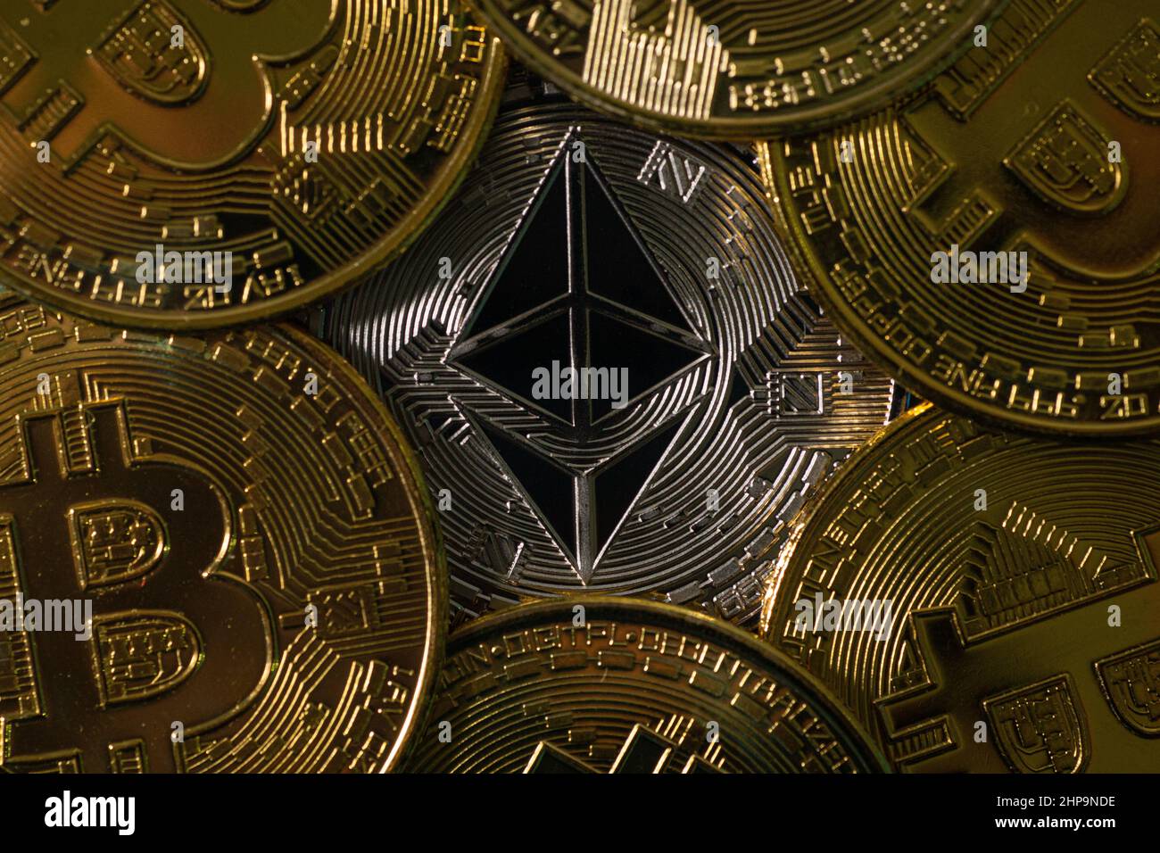 Silver Ethereum token among golden Bitcoin tokens. Digital currency ...