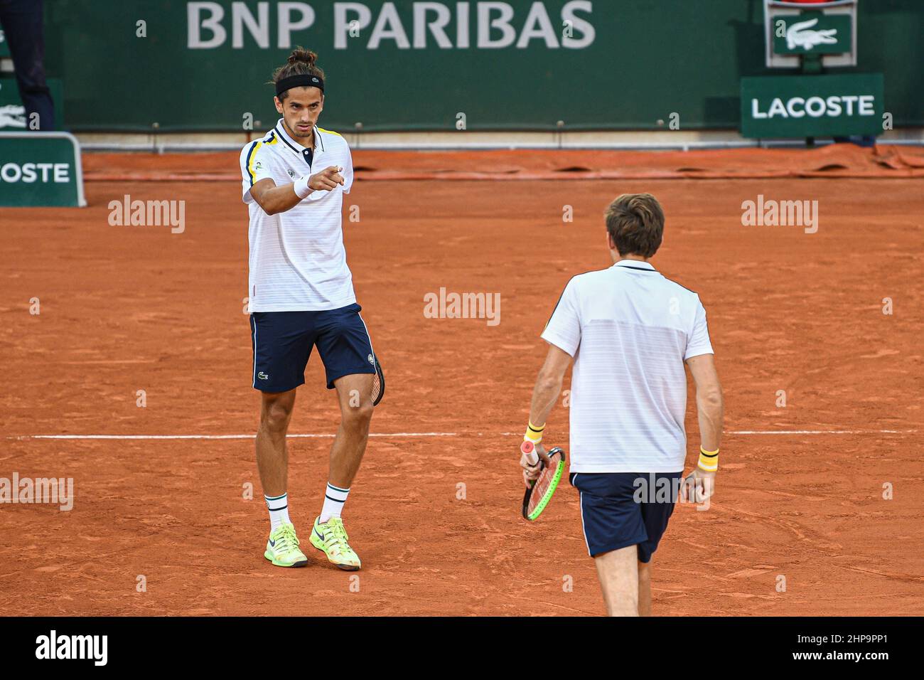 Pierre-Hugues Herbert (L) and Nicolas Mahut of France react during the ...