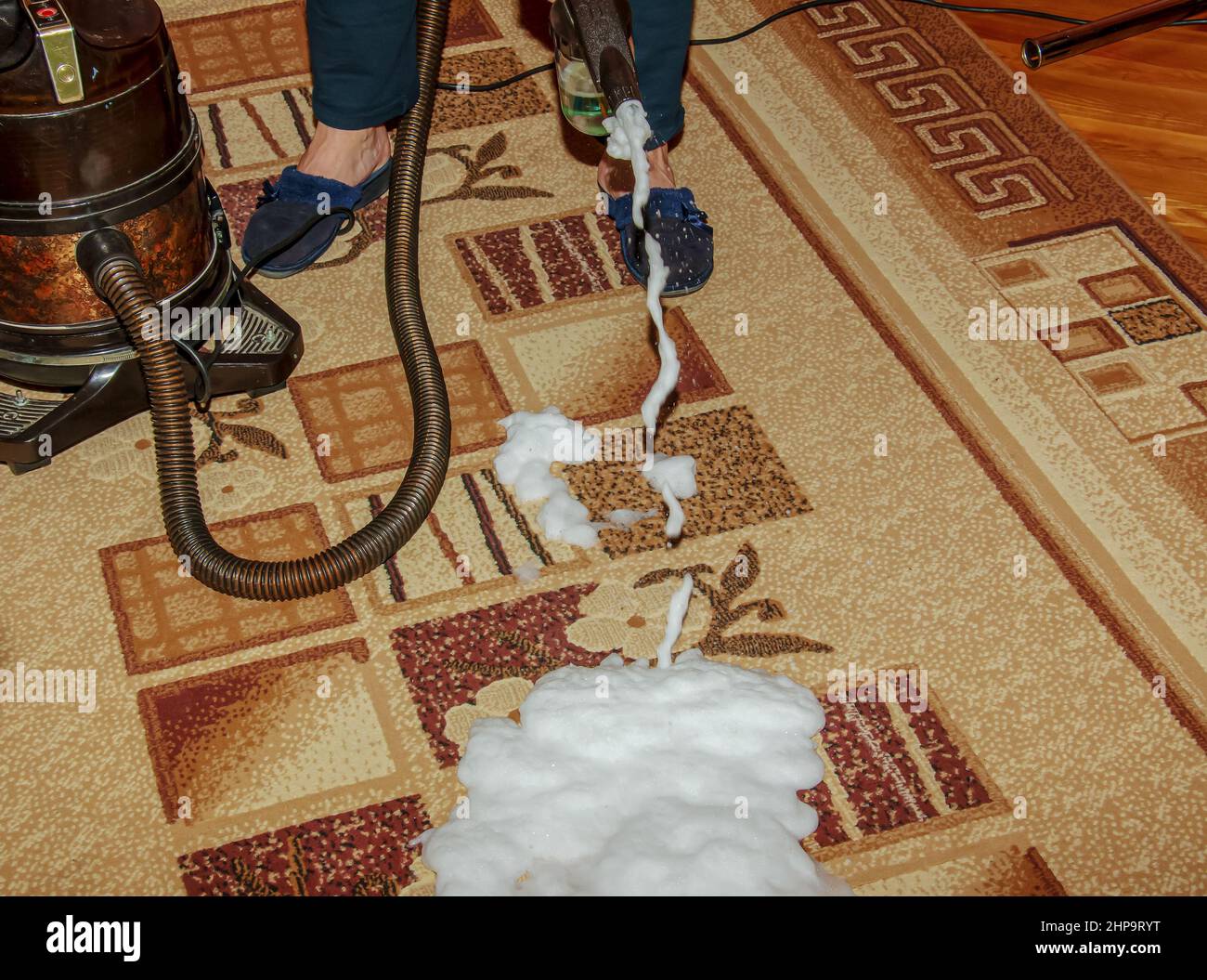 The process of cleaning the carpet with a vacuum cleaner with a water ...