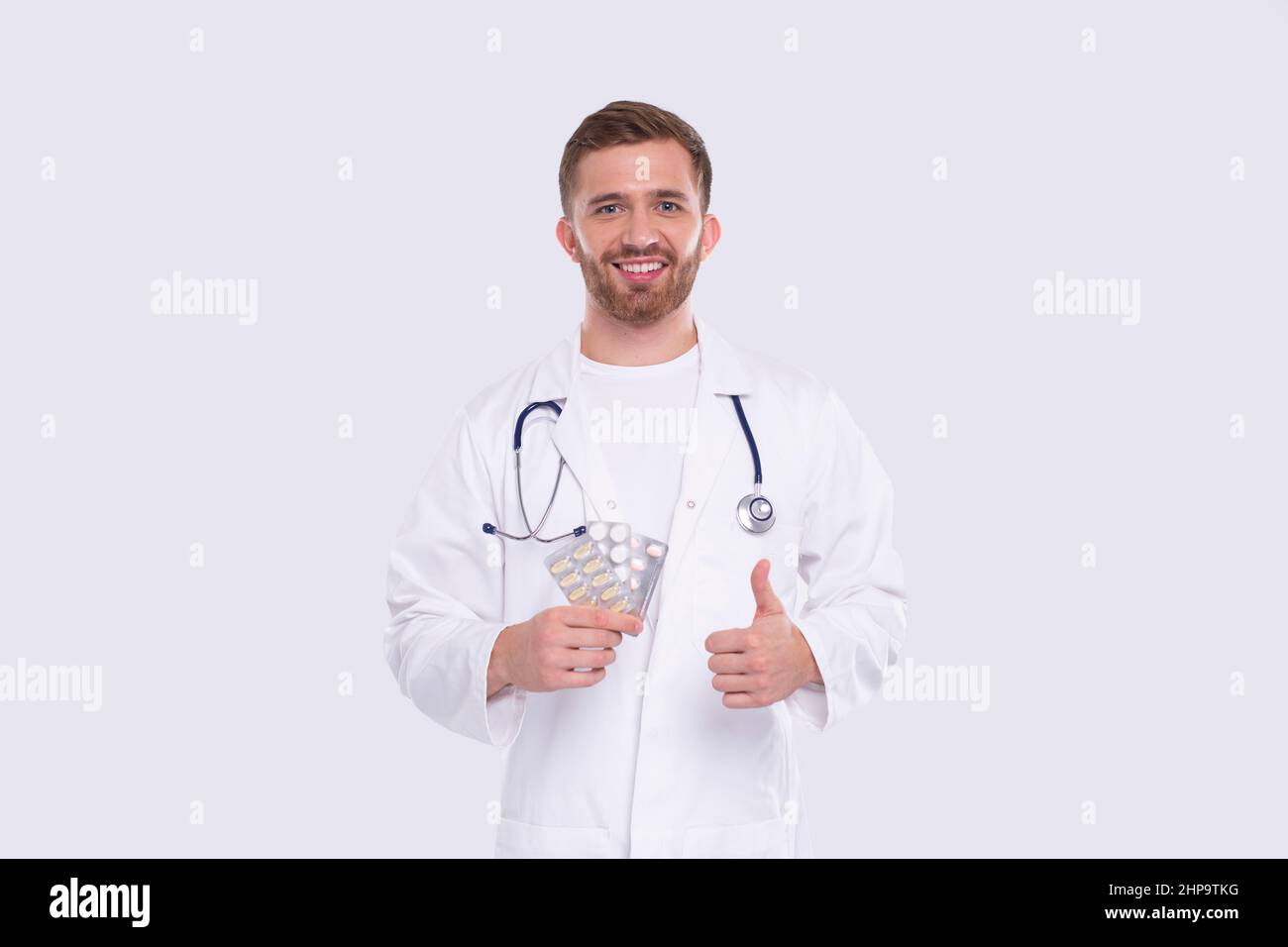 Man Doctor Showing Pills and Thumb Up. Doctor Holding Tablets Isolated ...