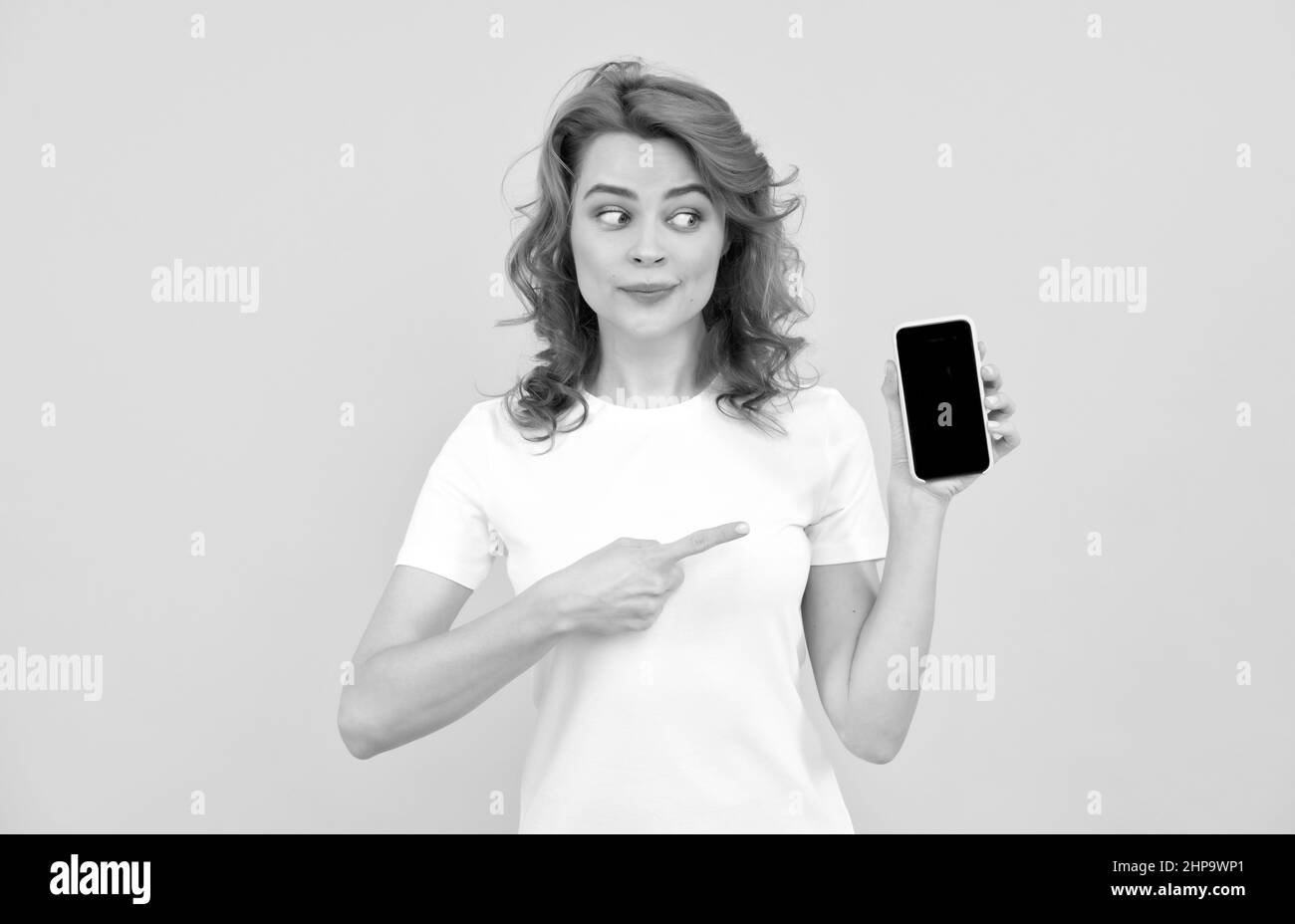 Packed with features. pointing finger cell phone. show mobile device ...