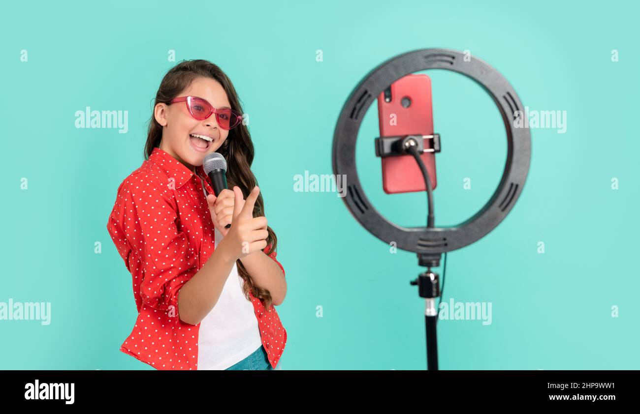 cheerful kid music blogger. karaoke. child singing song. vlogger with ...