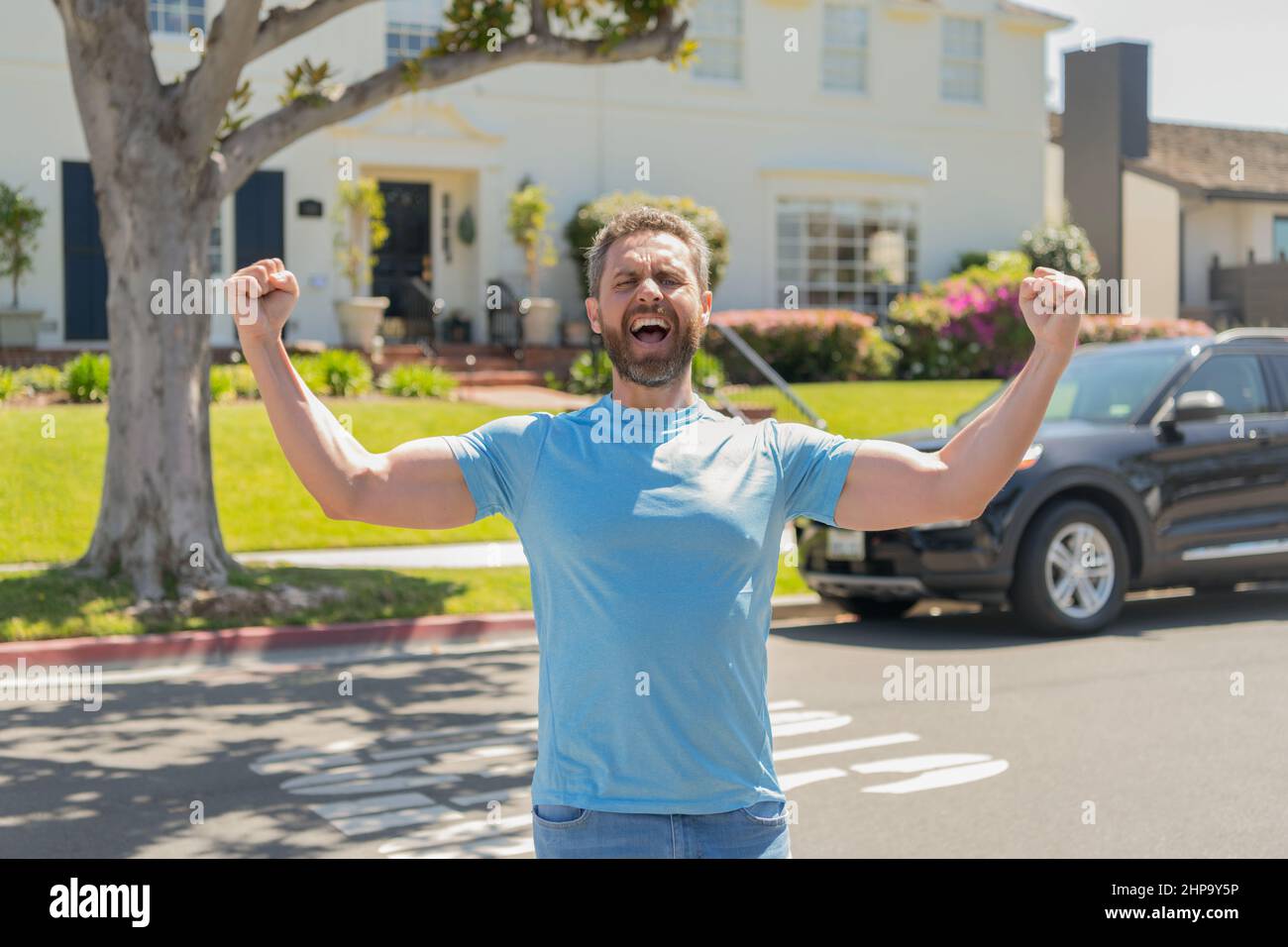 shouting guy standing next to car and house in neighborhood Stock Photo ...