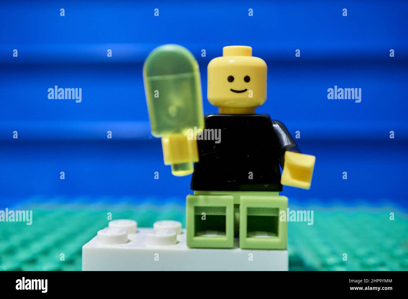 Lego man figurine holding something in its hands Stock Photo - Alamy