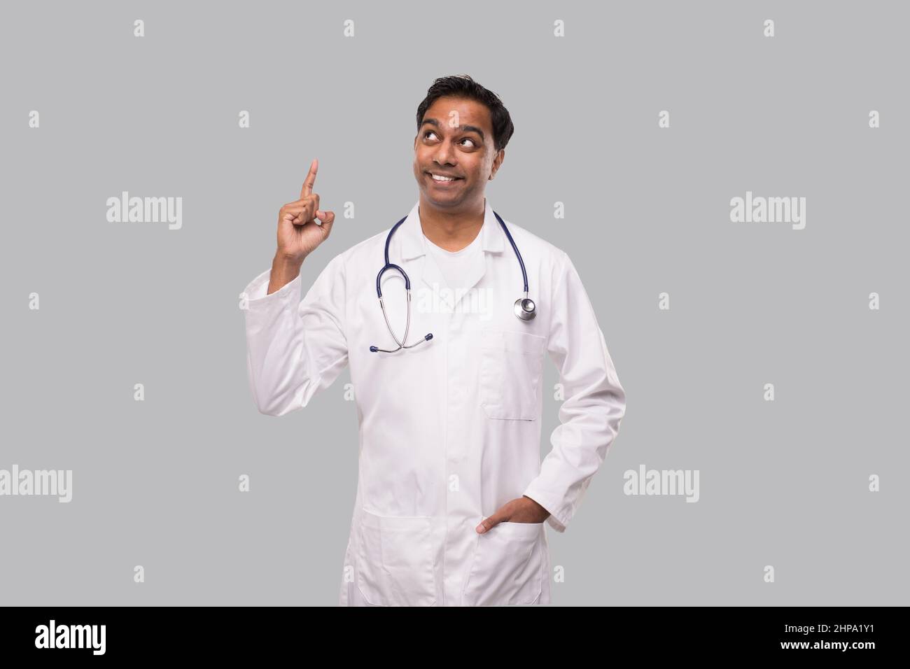 Indian Man Doctor Pointing Up and Watching Up. Isolated Stock Photo - Alamy