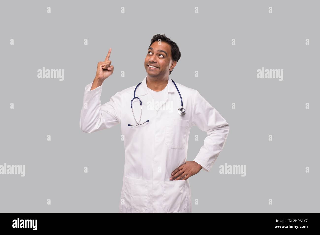 Indian Man Doctor Pointing Up and Watching Up. Isolated Stock Photo - Alamy