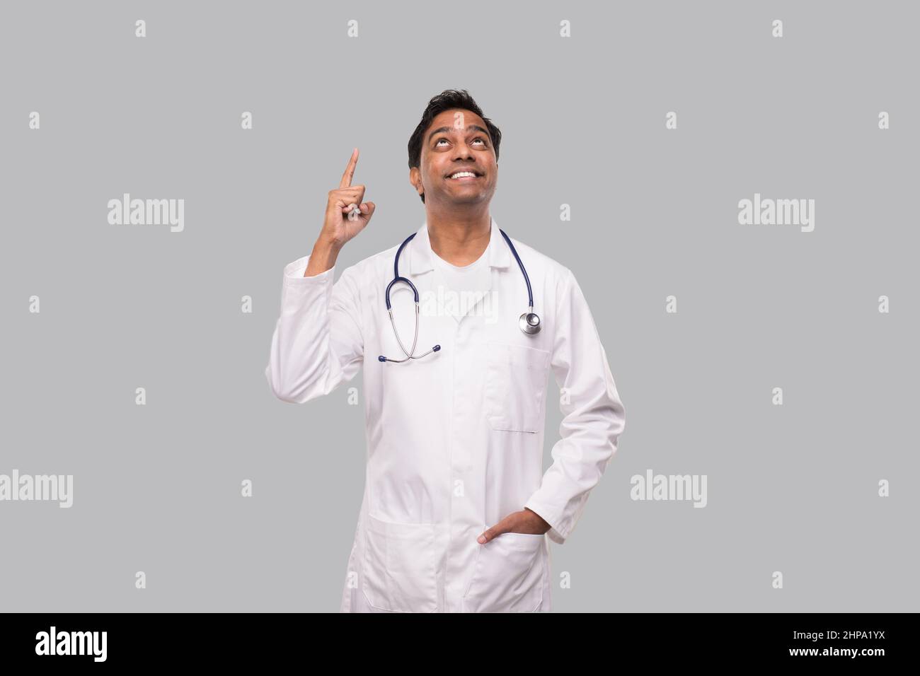 Indian Man Doctor Pointing Up and Watching Up. Isolated Stock Photo - Alamy