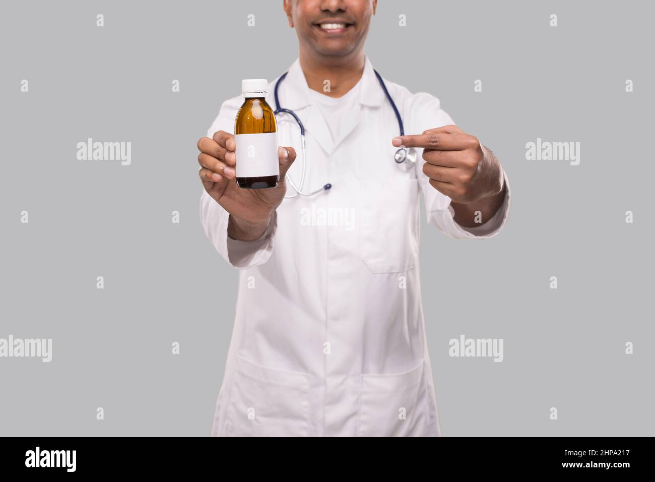 Doctor Pointing at Cough Syrup Close Up Isolated Stock Photo - Alamy