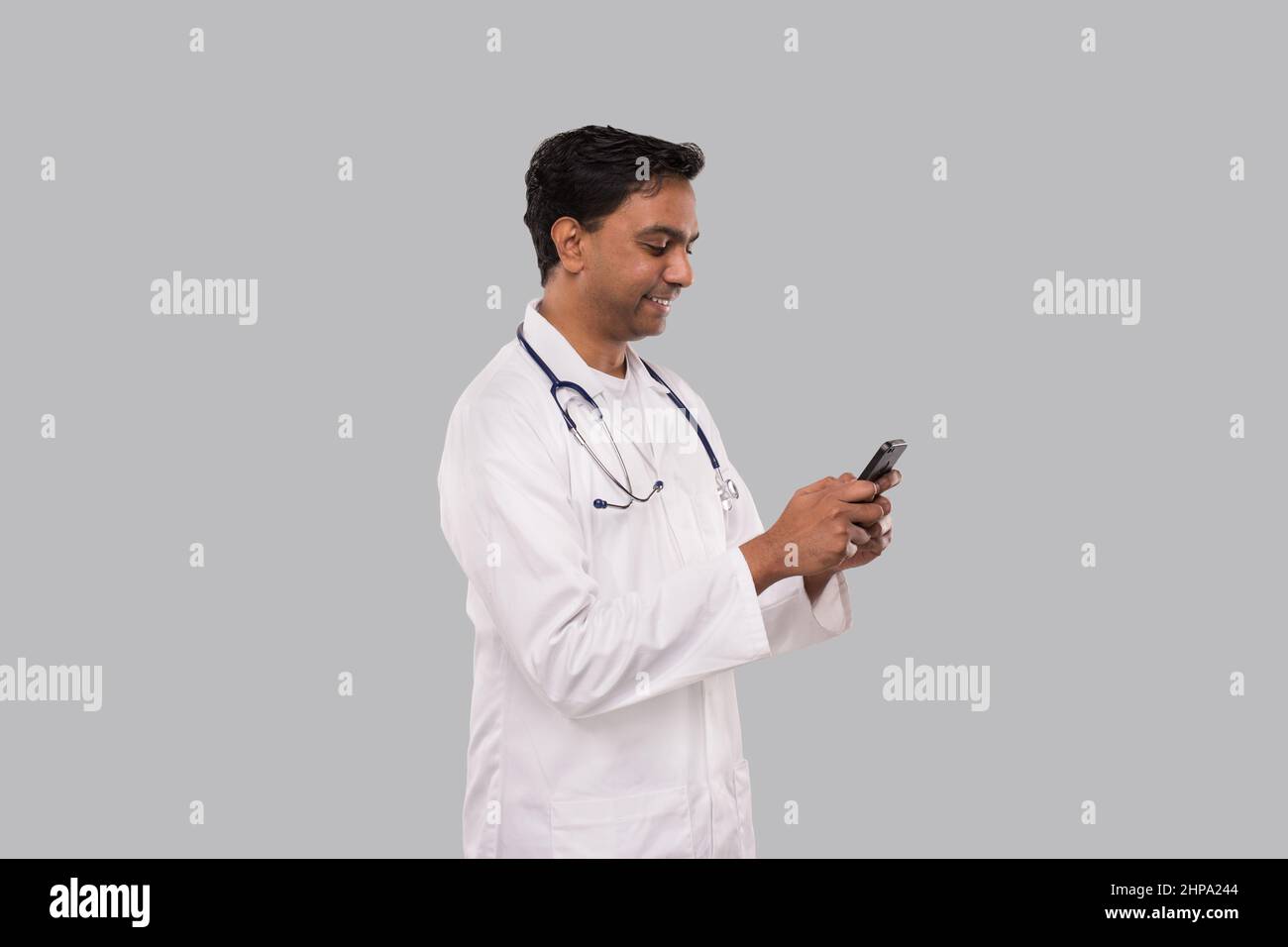 Doctor Chatting on the Phone Isolated. Indian Man Doctor With Phone ...