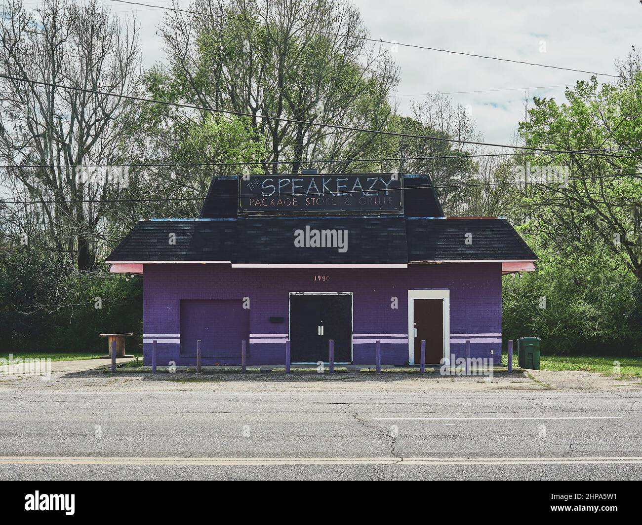 Small liquor store or package store, bar and grill front exterior in a ...