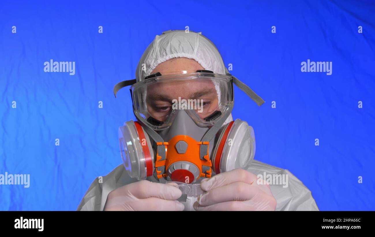 Scientist virologist in respirator. Slow motion. Man close up look ...