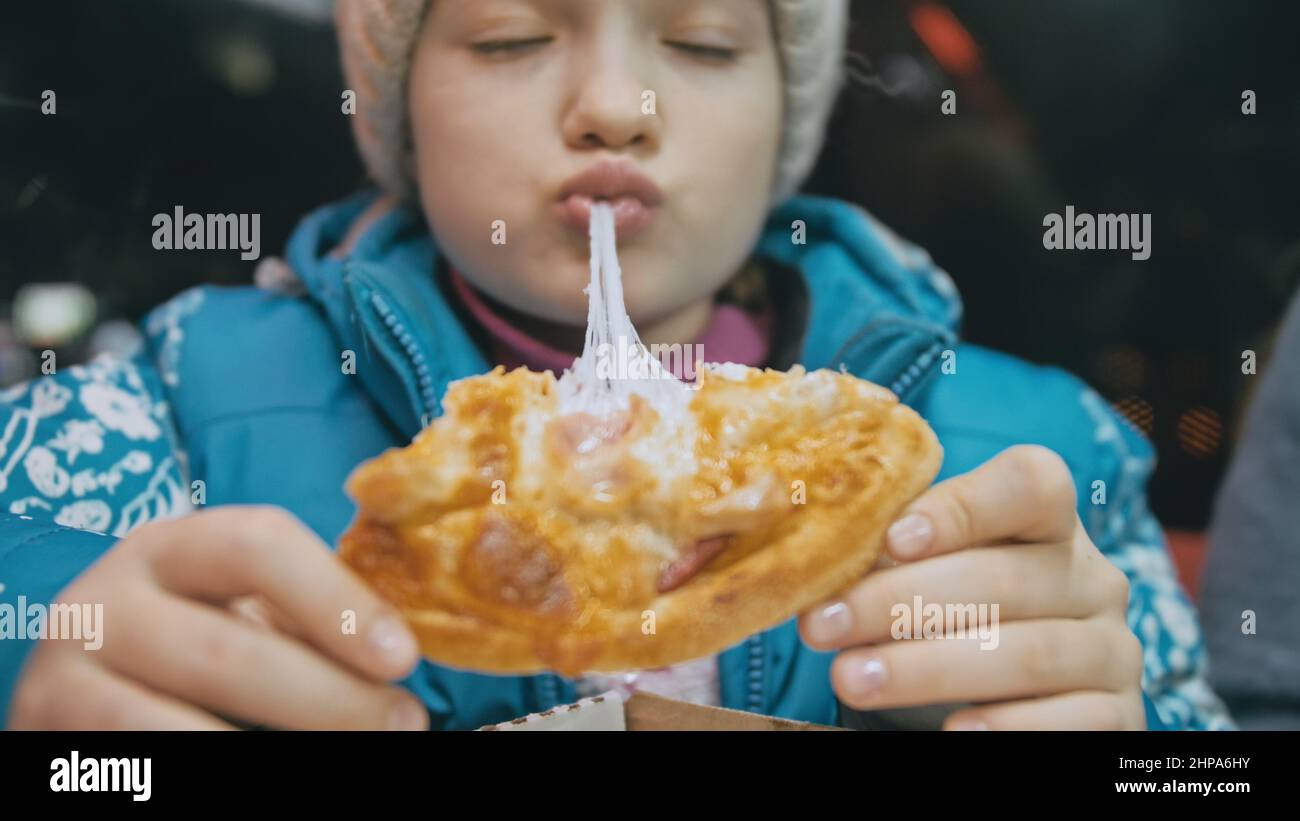 Child eat pizza cheese four. Close up of young girl woman mouth ...