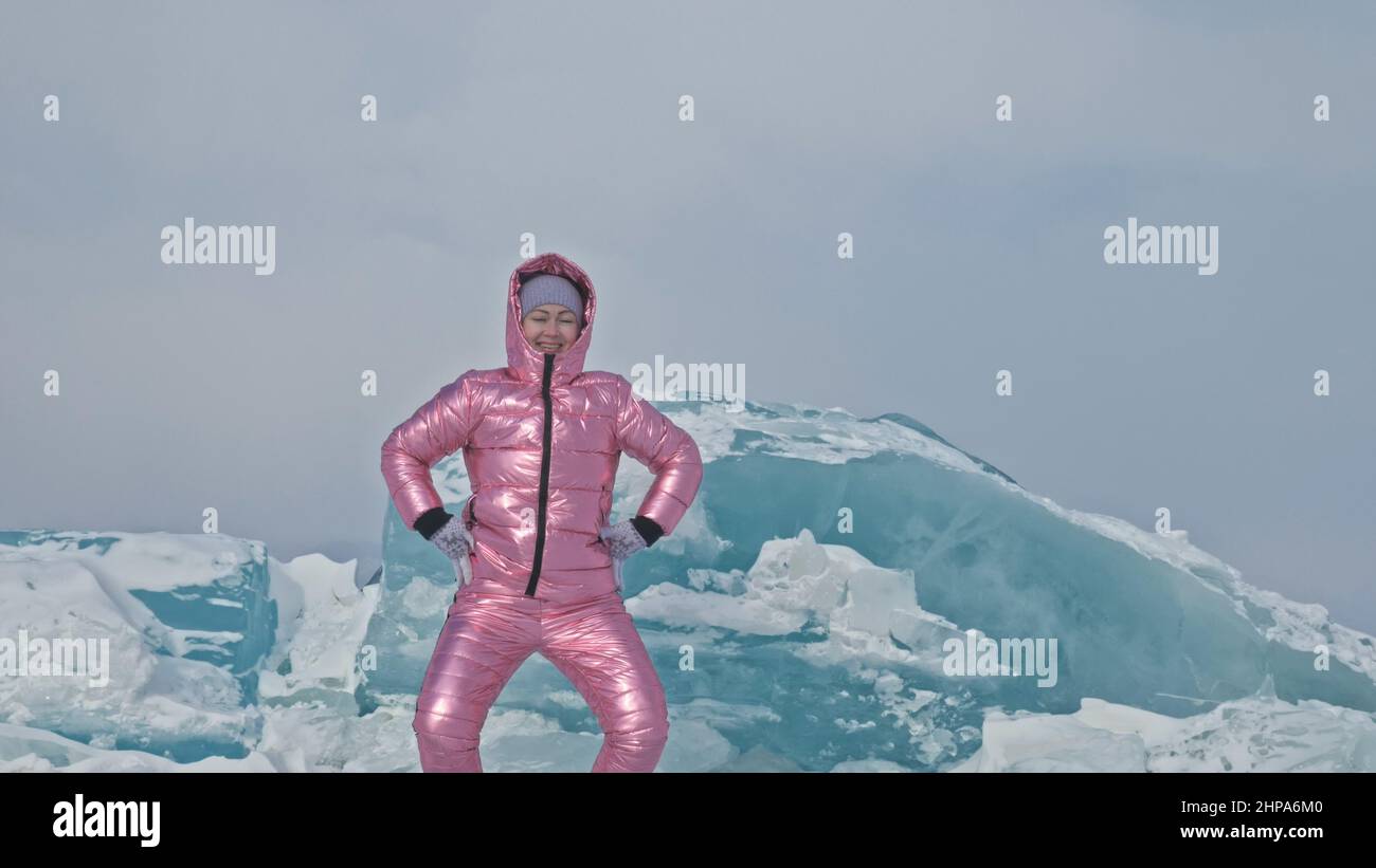 Girl walking on cracked ice of frozen lake Baikal. Woman traveler ...