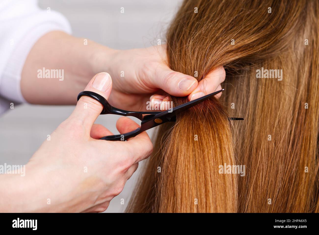 Woman hair care. Hairdresser making hairstyle to young girl in beauty ...