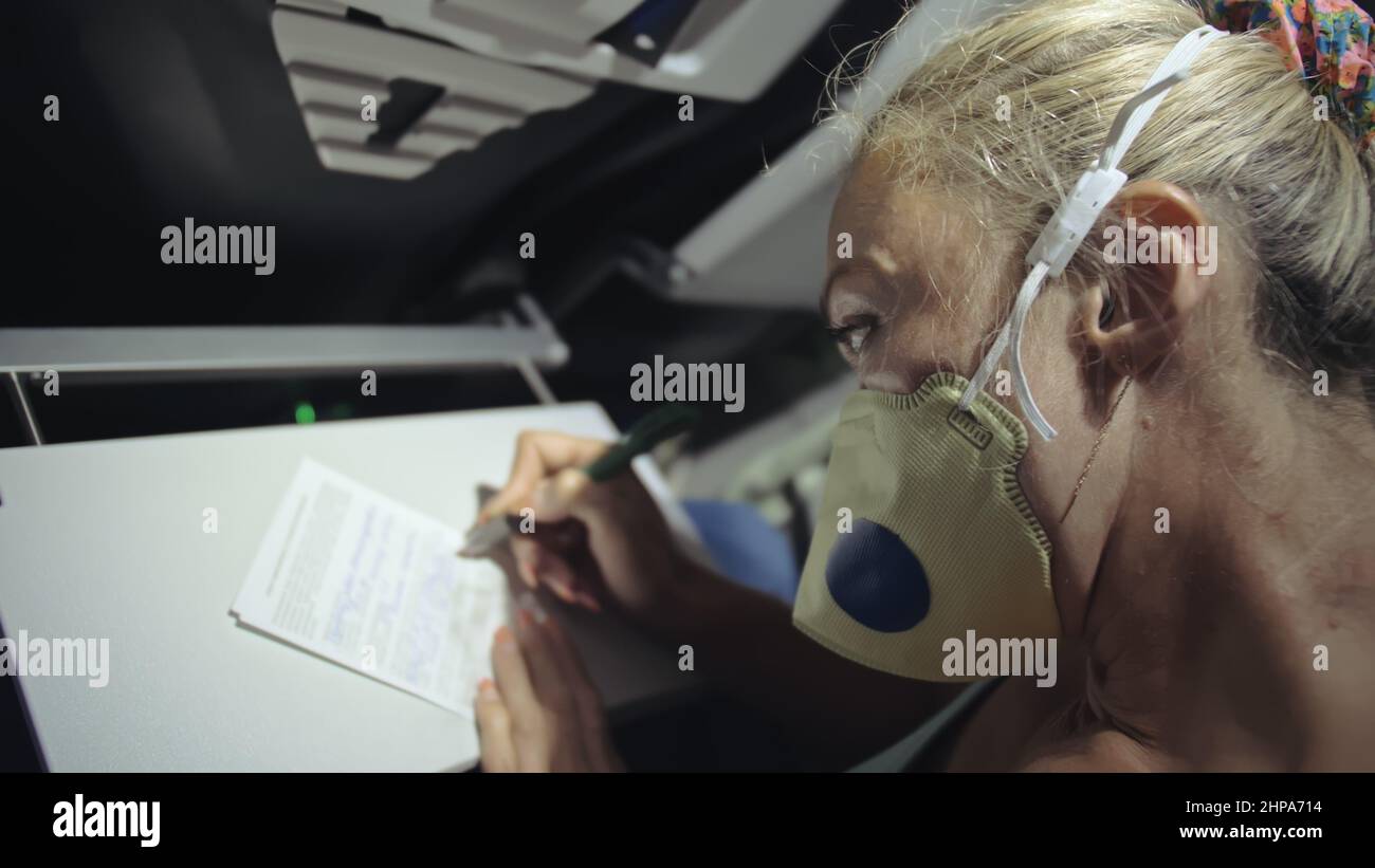 Woman travel caucasian at plane with wearing protective medical mask ...